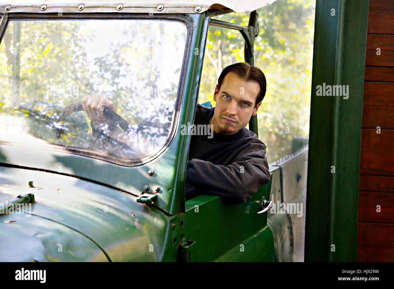 Coming back through the gate with an old truck Stock Photo - Alamy