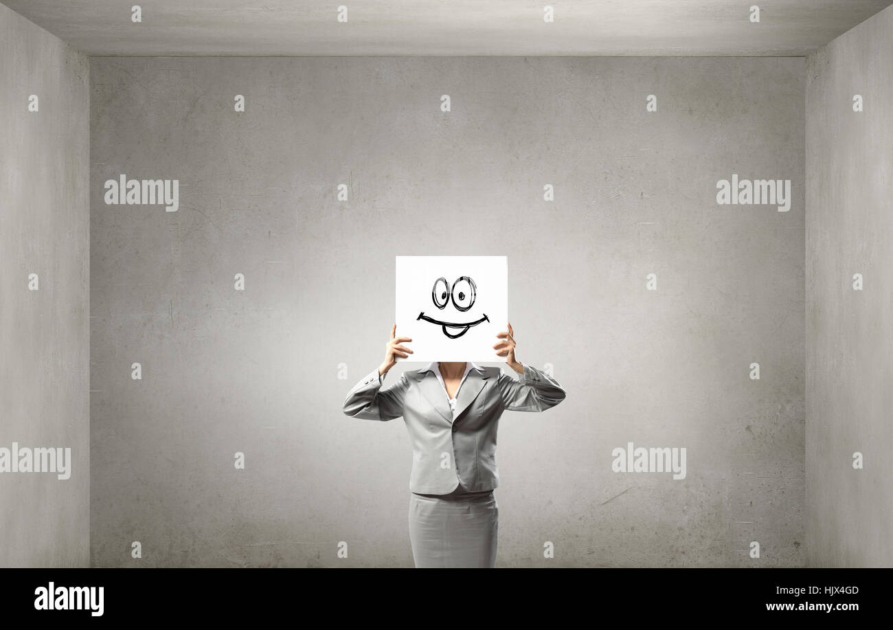Businesswoman hiding her face behind paper list hi-res stock ...