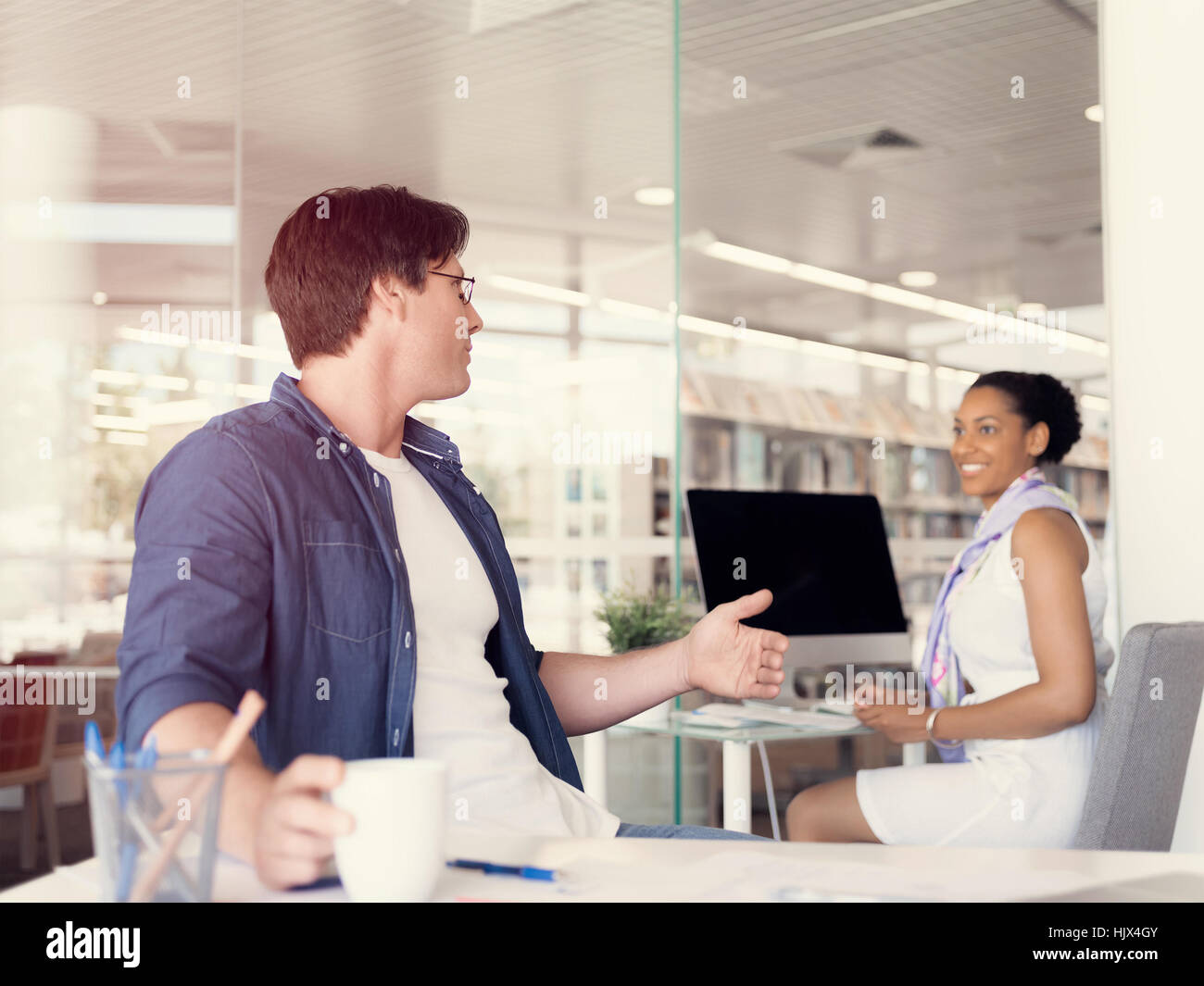Conversation young businessmen in office hi-res stock photography and ...