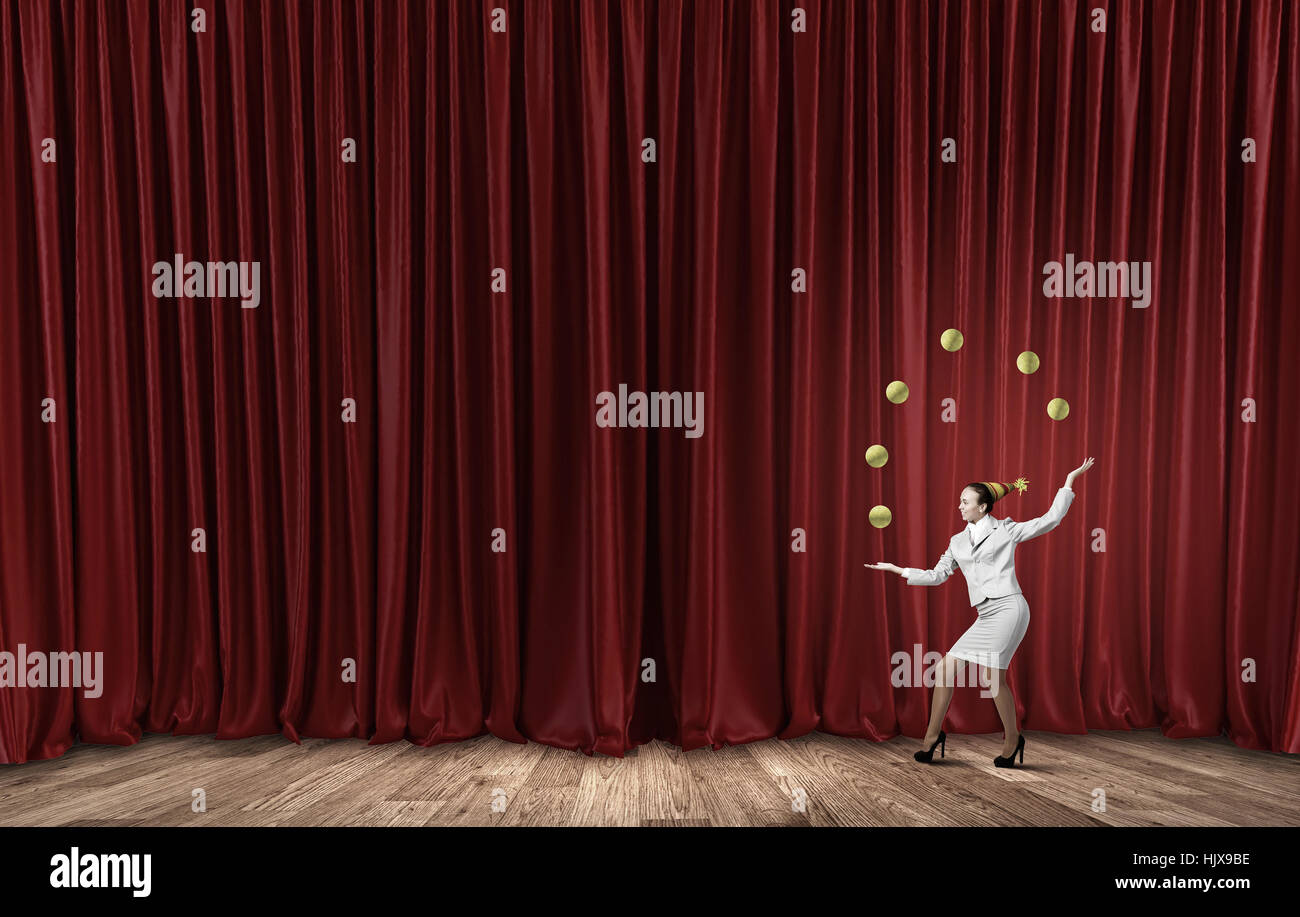 Young businesswoman in cap on stage juggling with balls Stock Photo - Alamy