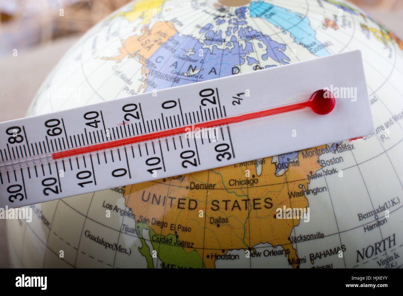 Thermometer placed on a little model globe Stock Photo - Alamy