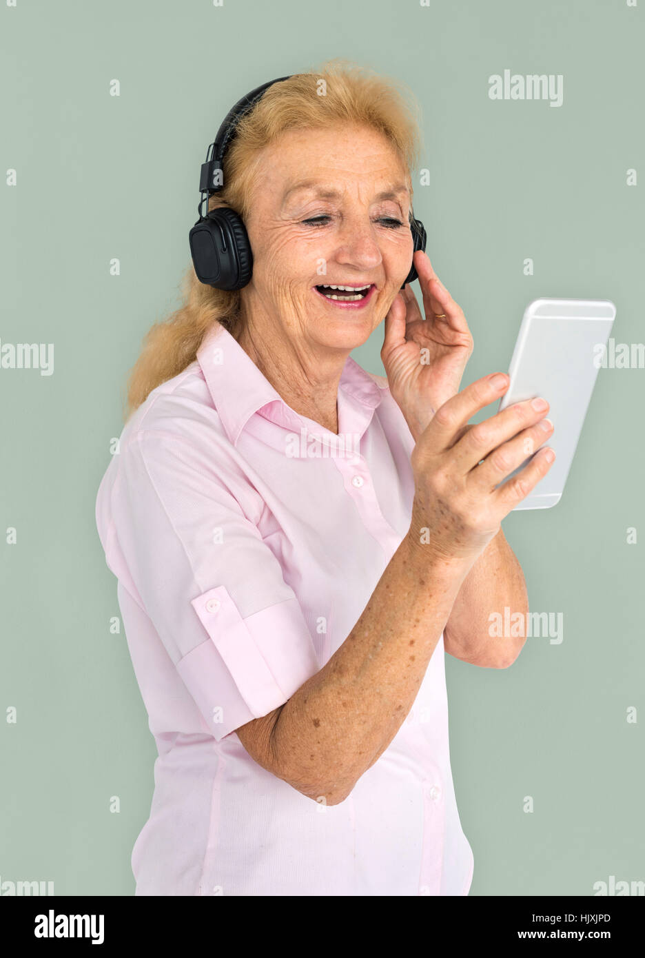Senior Adult Use Mobile Headphone Concept Stock Photo - Alamy