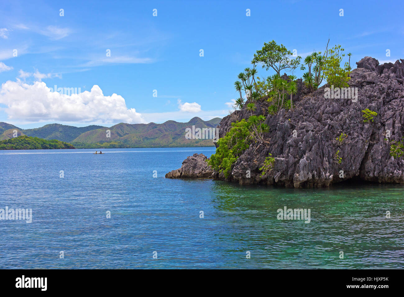 Sea waters of Coron Island lagoon with mountains on horizon ...