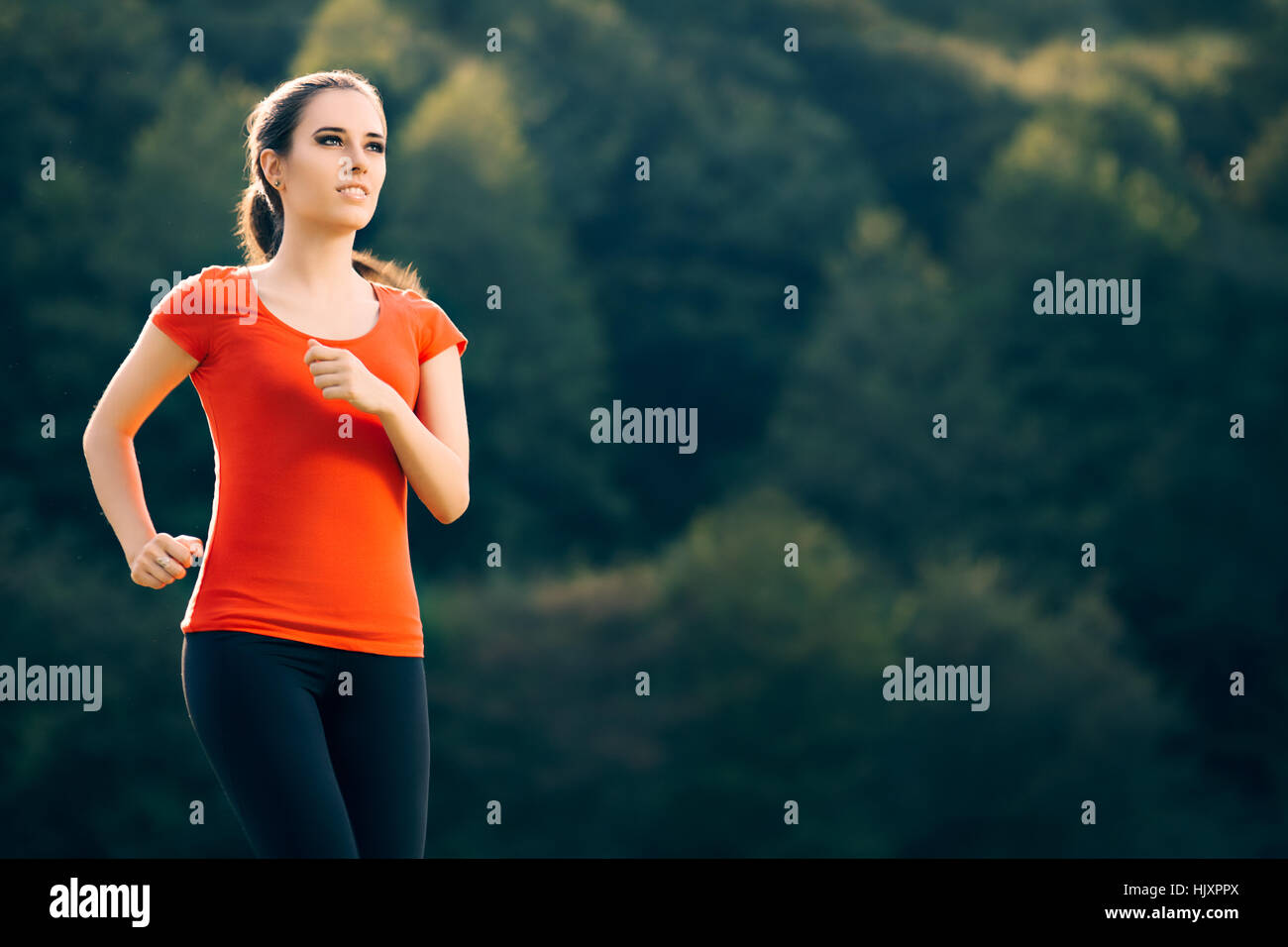 Fitness girl jogging in nature in a sunny day outoors Stock Photo - Alamy