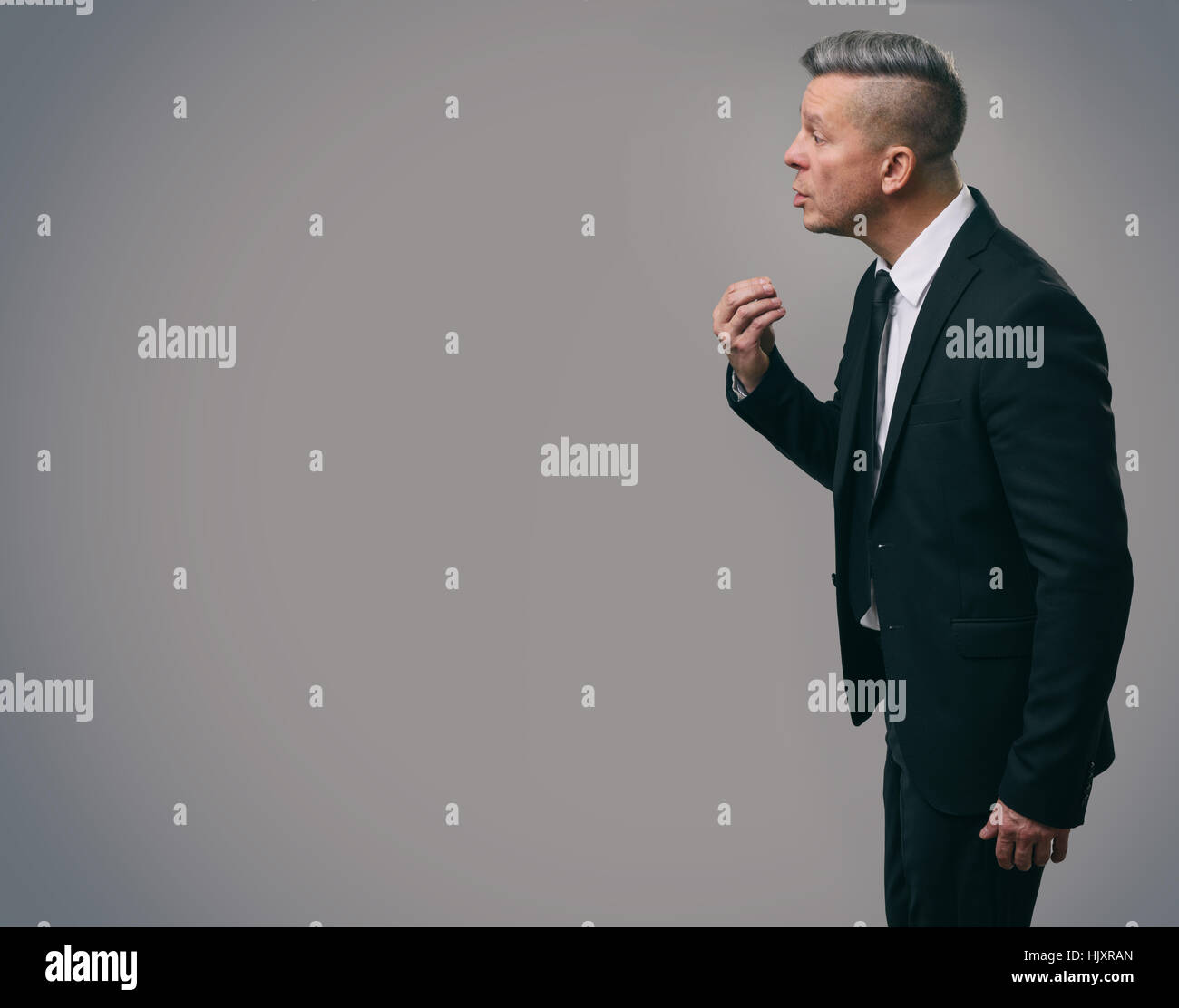 Senior business man talking with someone. Studio shot Stock Photo - Alamy