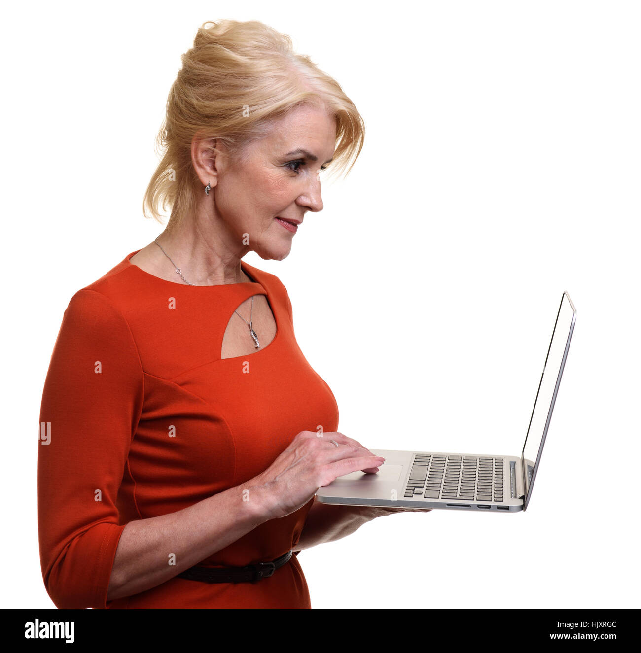 happy elderly woman using laptop computer isolated on white background ...