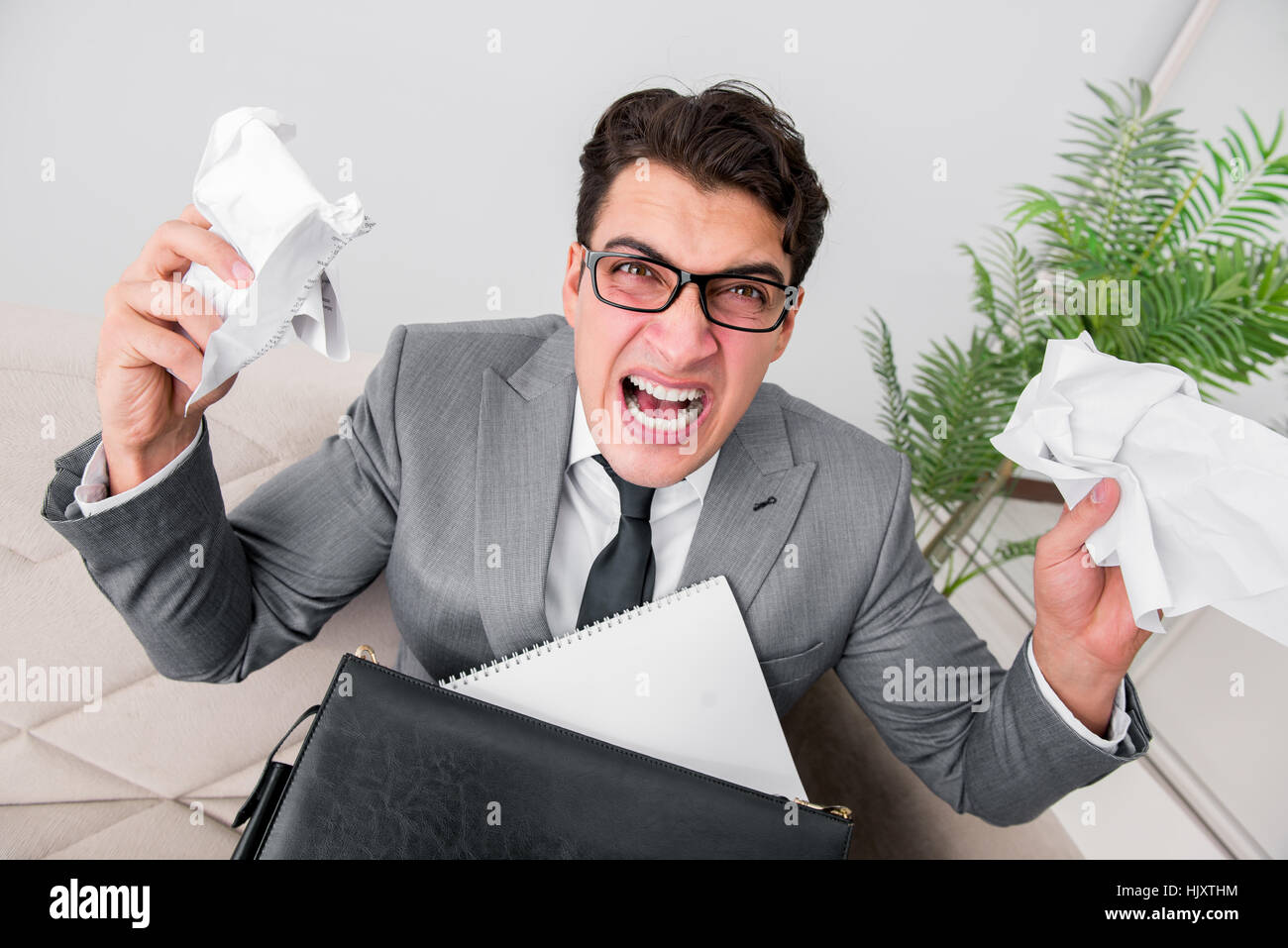 Angry businessman with crumbled paper Stock Photo - Alamy