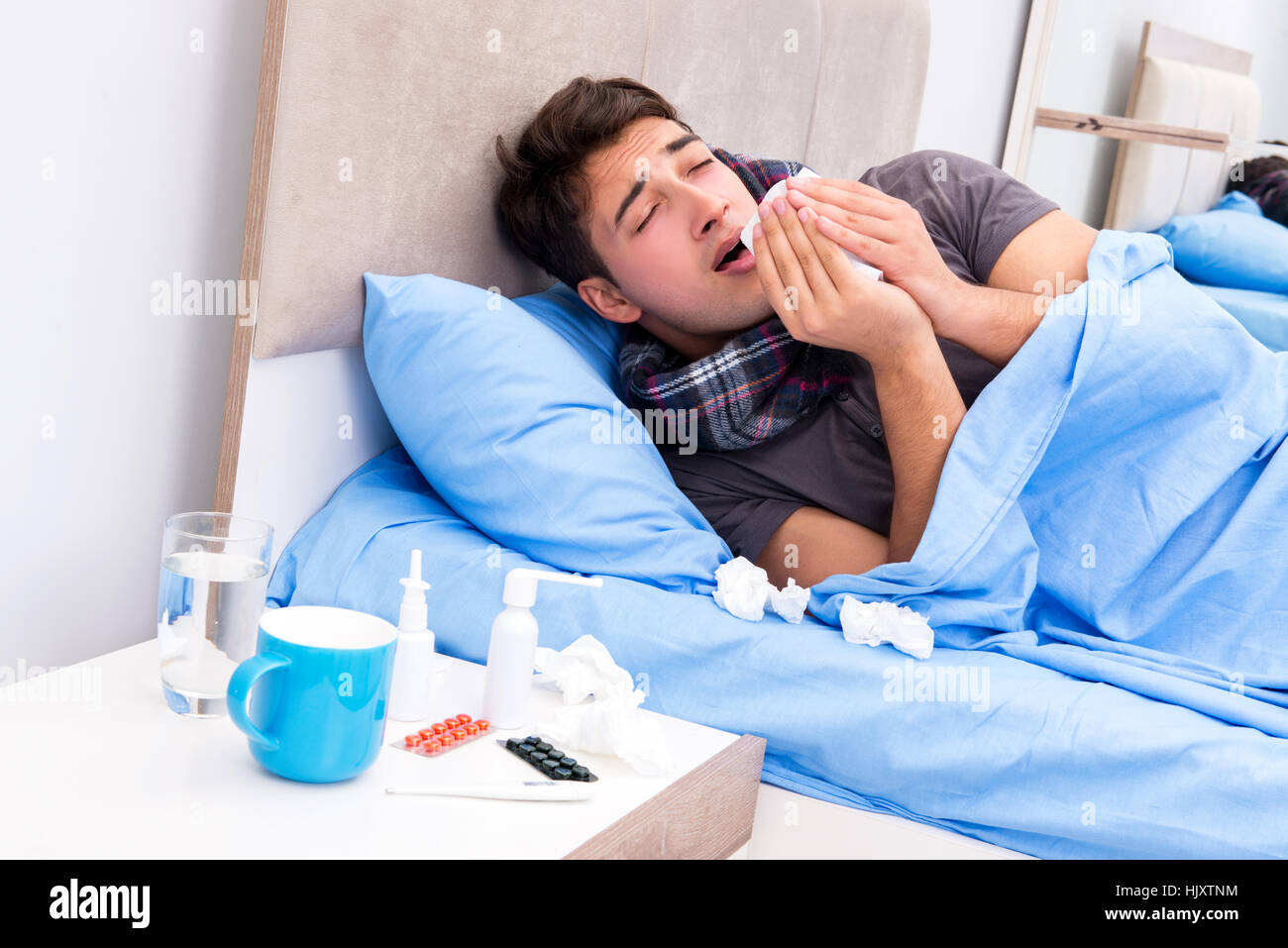 Sick man with flu lying in the bed Stock Photo - Alamy