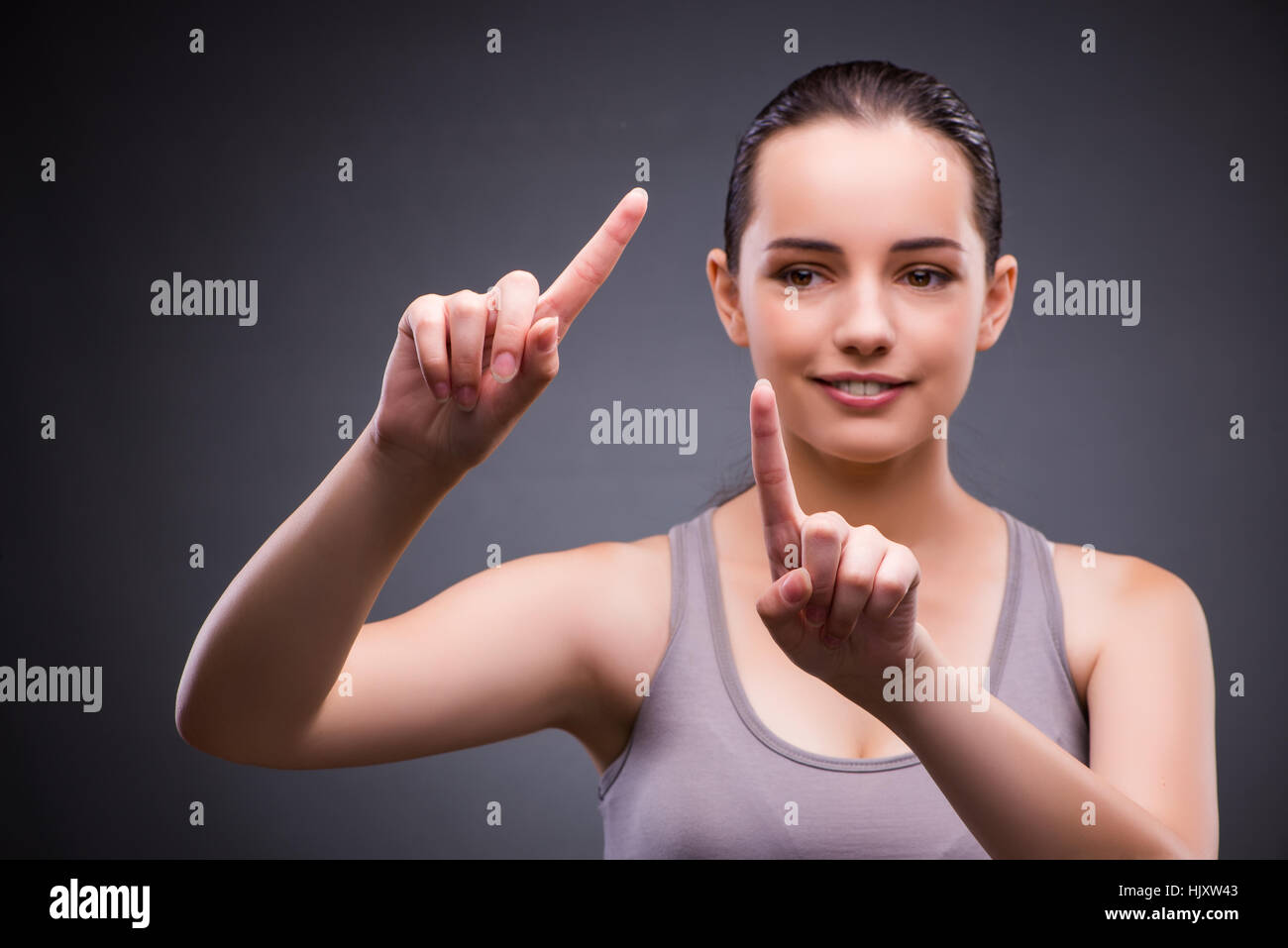 Young sports girl pressing virtual button Stock Photo - Alamy