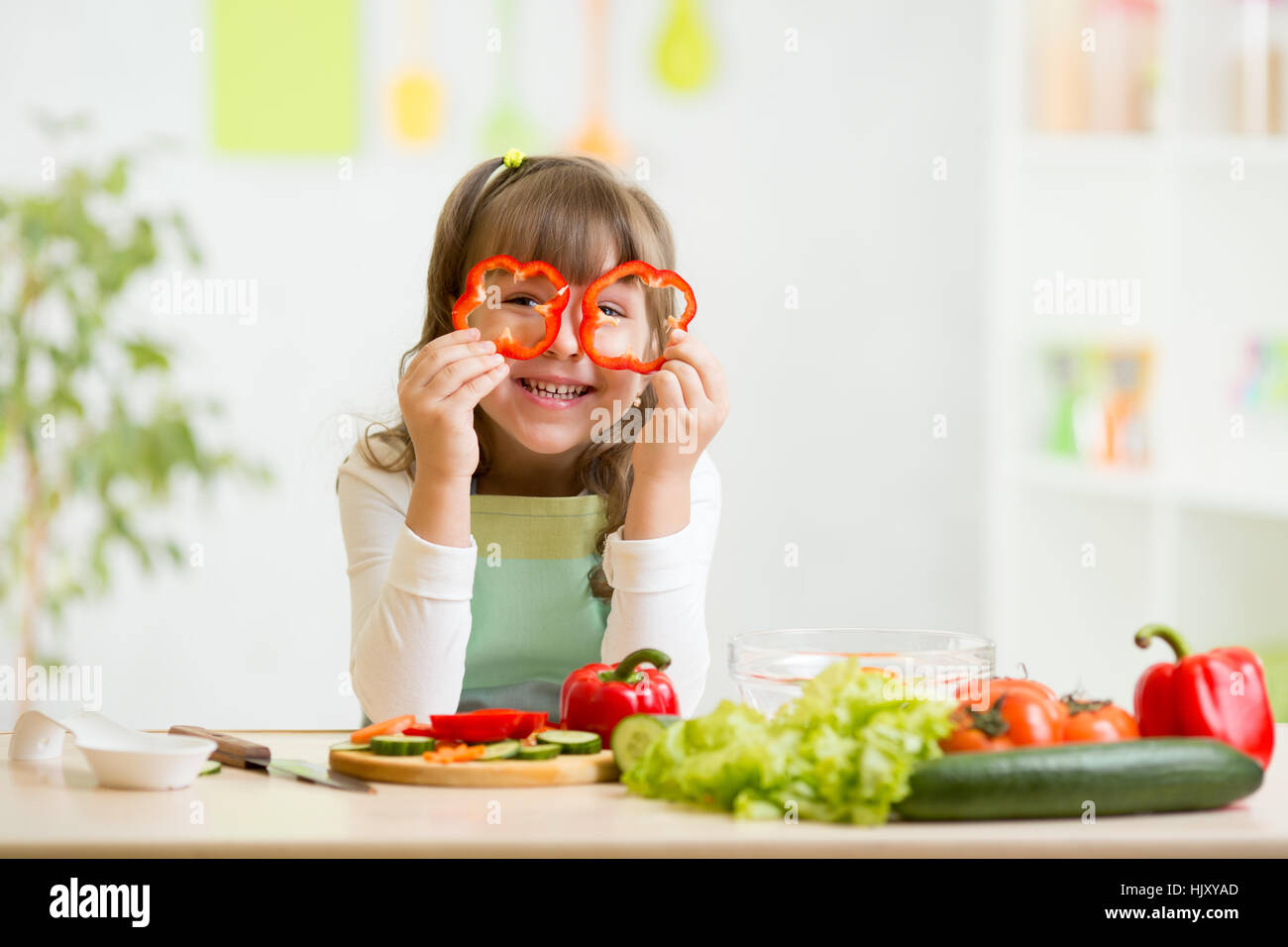 Child girl having fun with food vegetables at nursery room Stock Photo ...