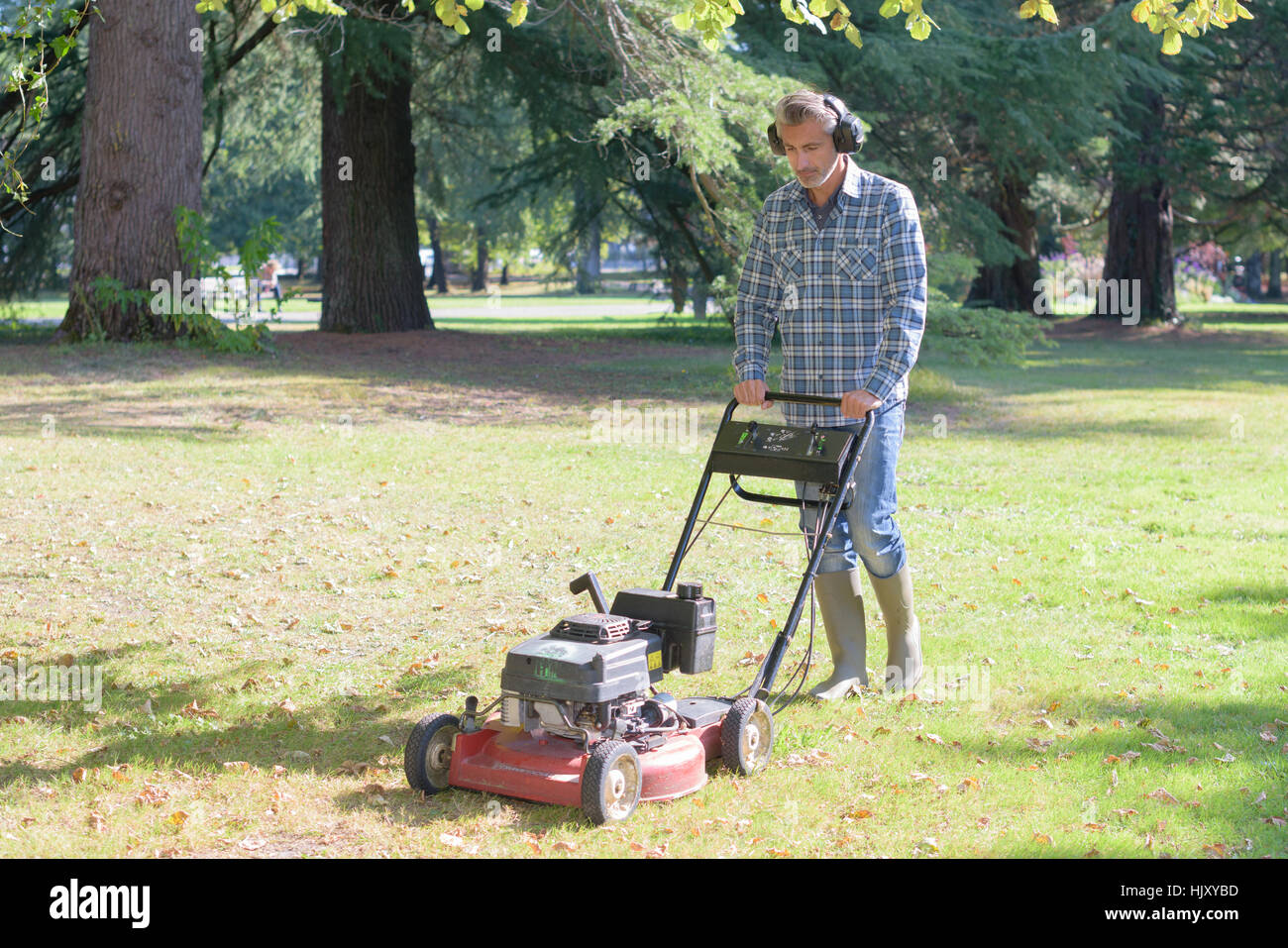 Man pushing mower Stock Photo - Alamy
