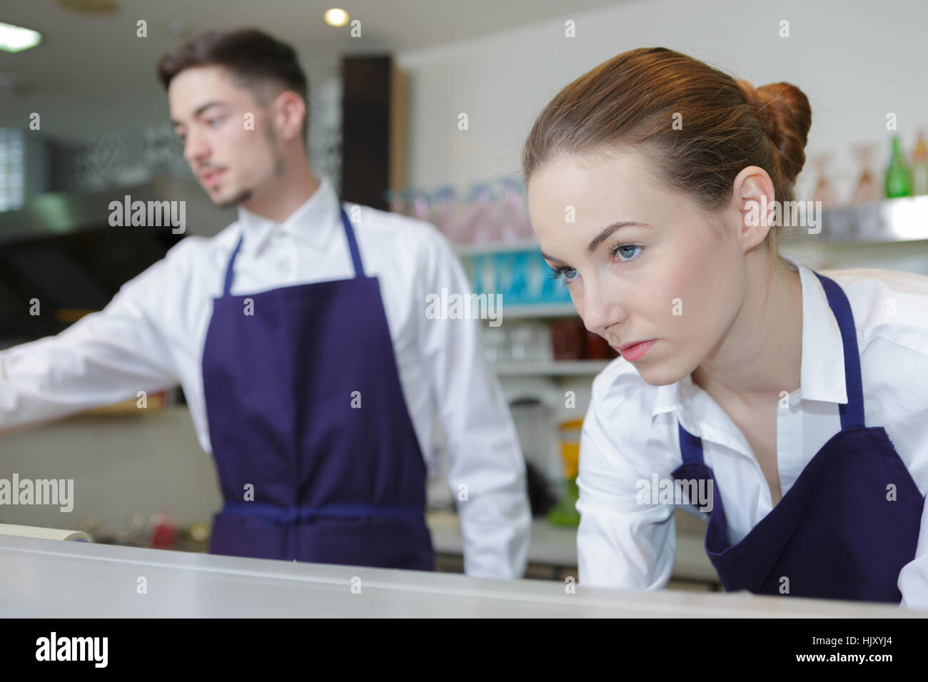waitress and waiter working in cafe Stock Photo - Alamy