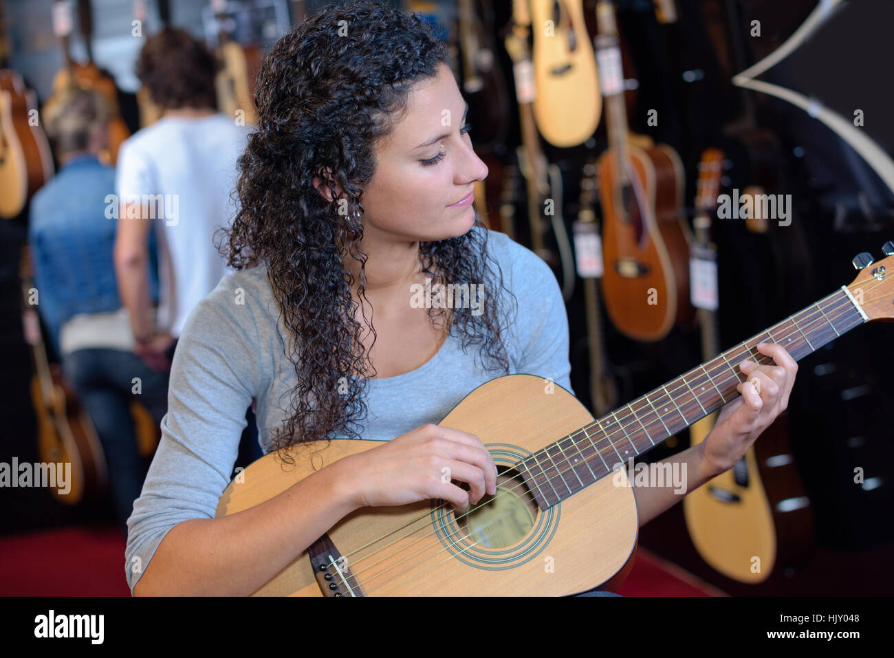 Lady playing accoustic guitar Stock Photo - Alamy