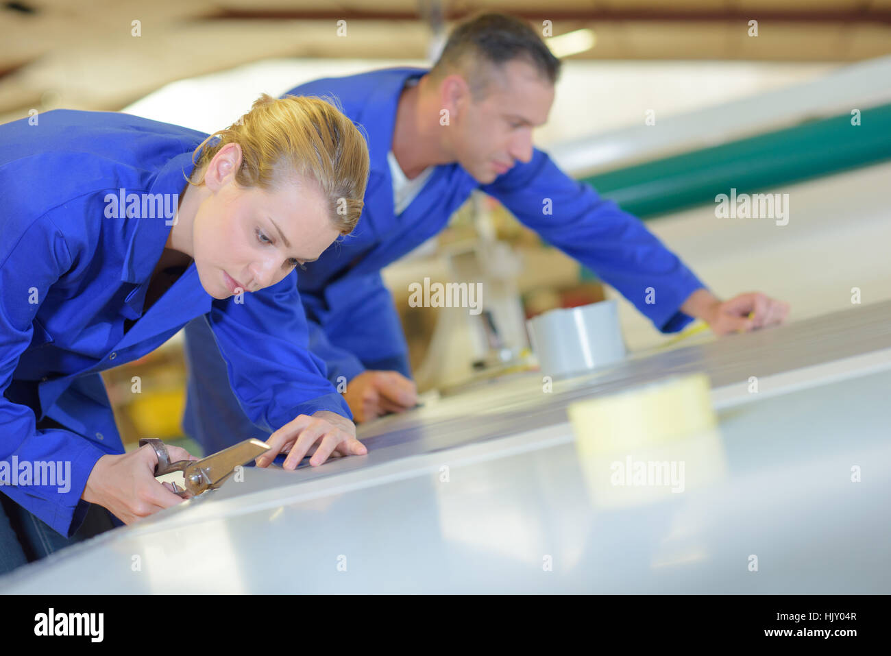 employees cutting canvas Stock Photo - Alamy