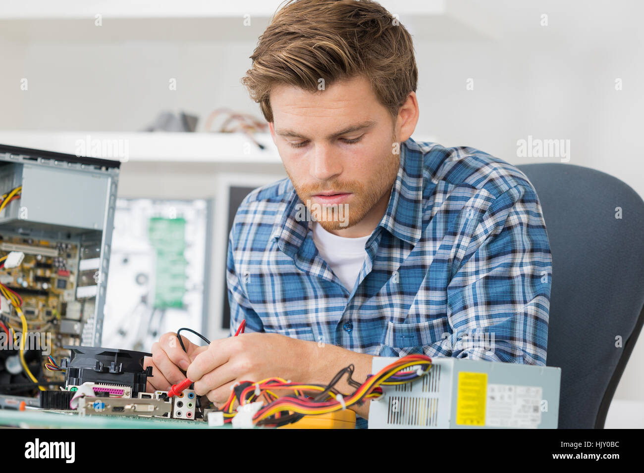 young man fixing computer Stock Photo - Alamy