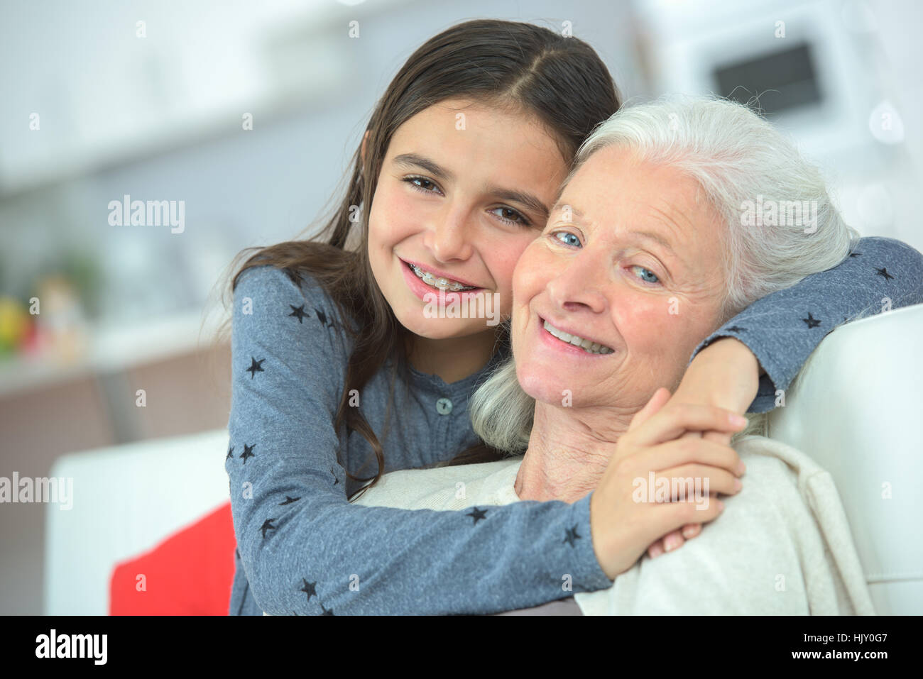Hugging her grandma Stock Photo - Alamy