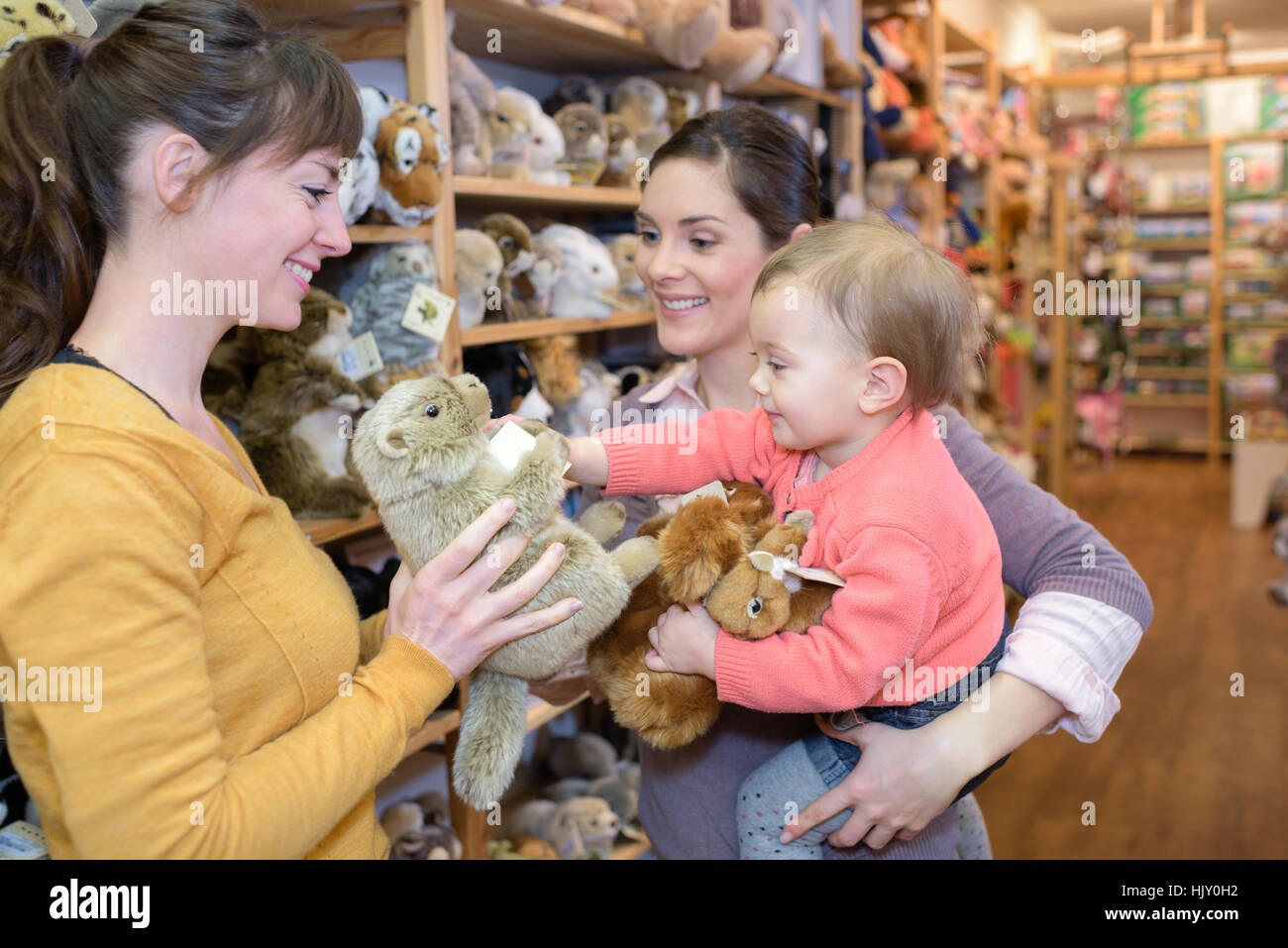 parents enjoying with their daughter in shopping mall Stock Photo - Alamy