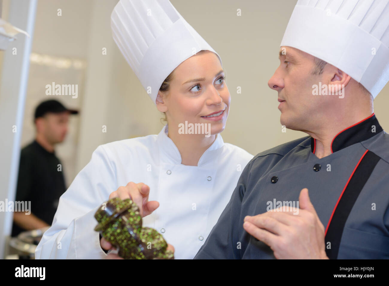 portrait of a cheerful professional cooks at work in kitchen Stock ...