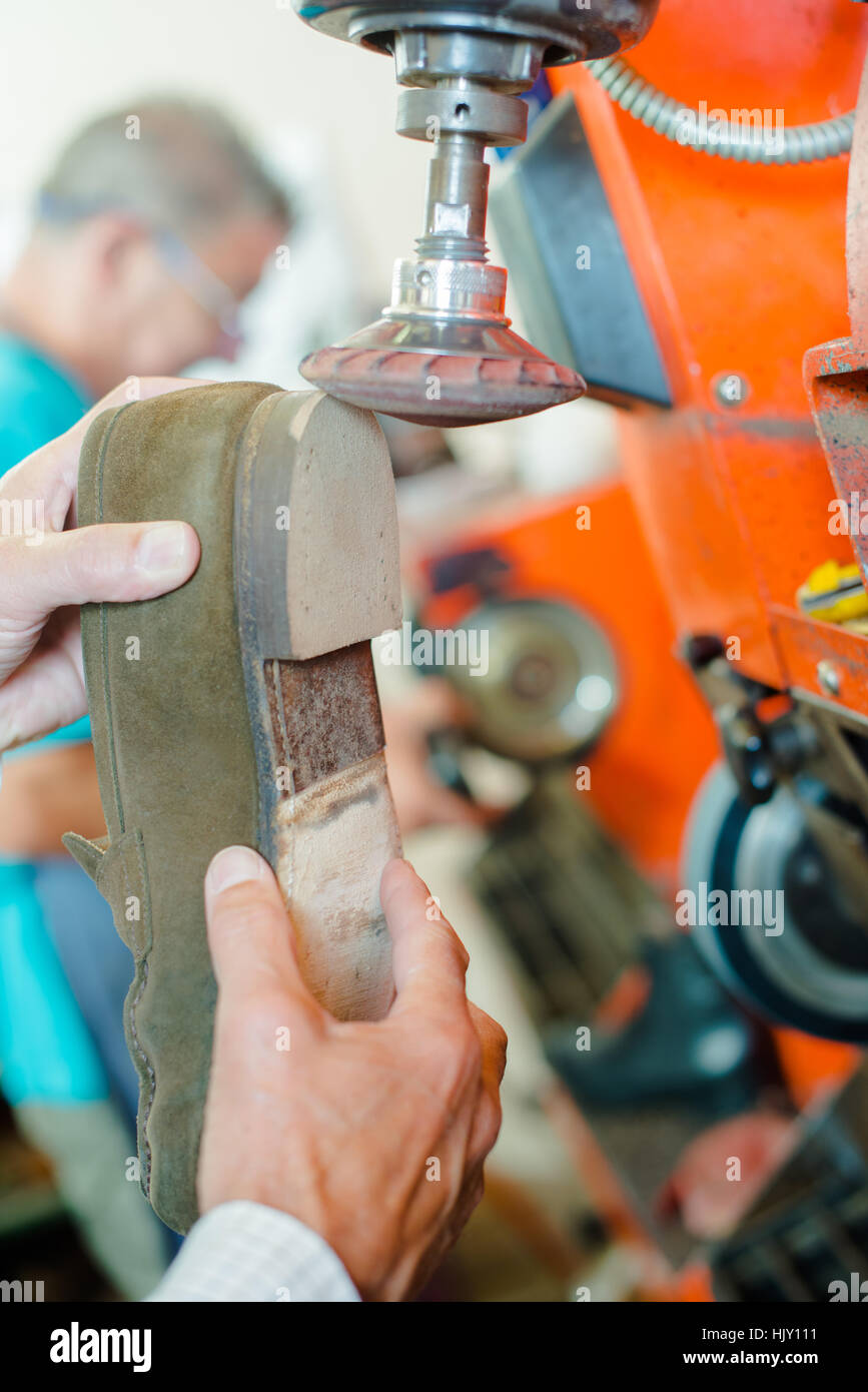 cobbler sanding shoe Stock Photo - Alamy