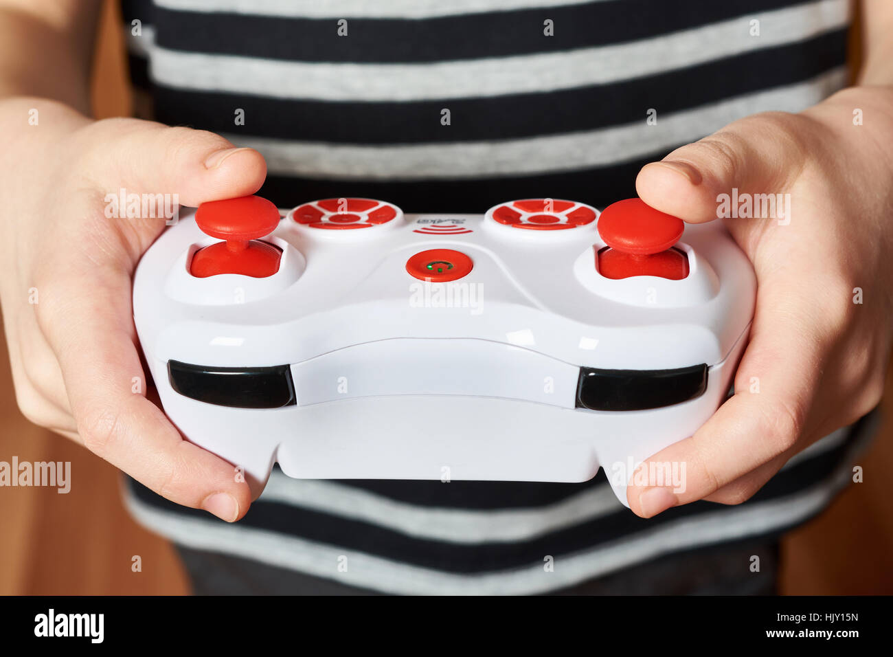 Child hands use remote control of drone Stock Photo - Alamy