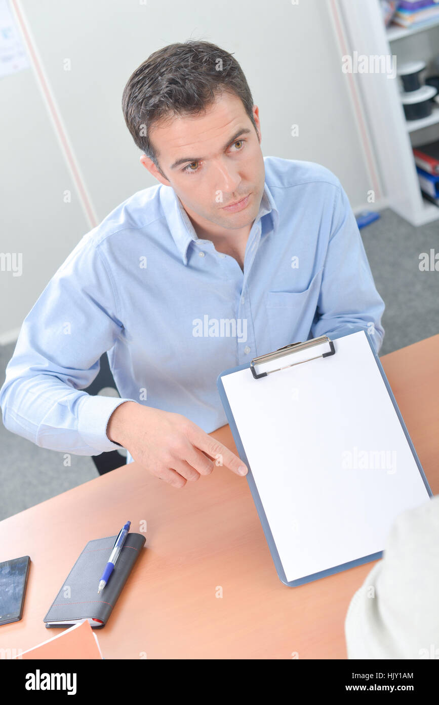 Man presenting clipboard to client Stock Photo - Alamy