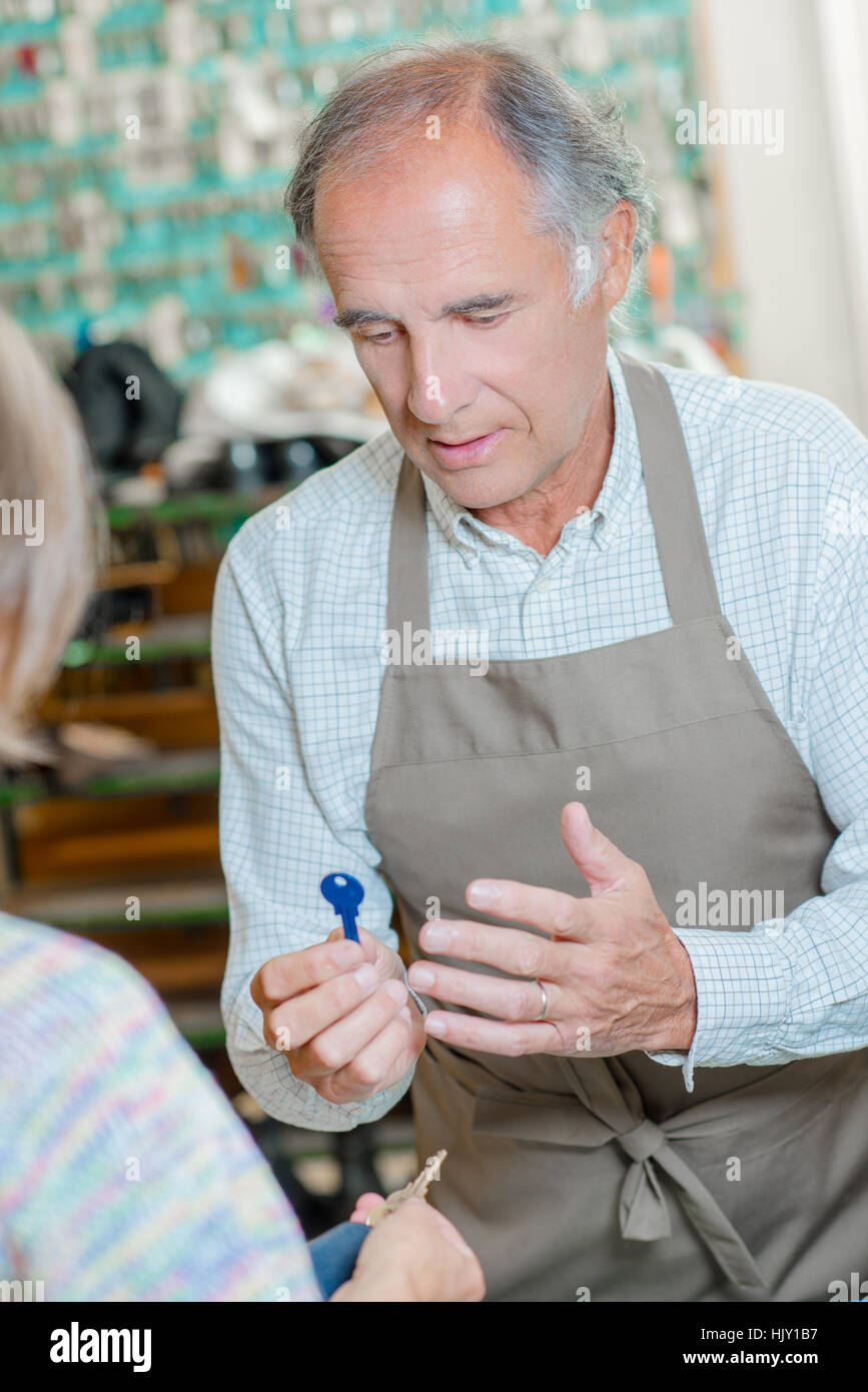 Shopkeeper selling a duplicate key Stock Photo - Alamy