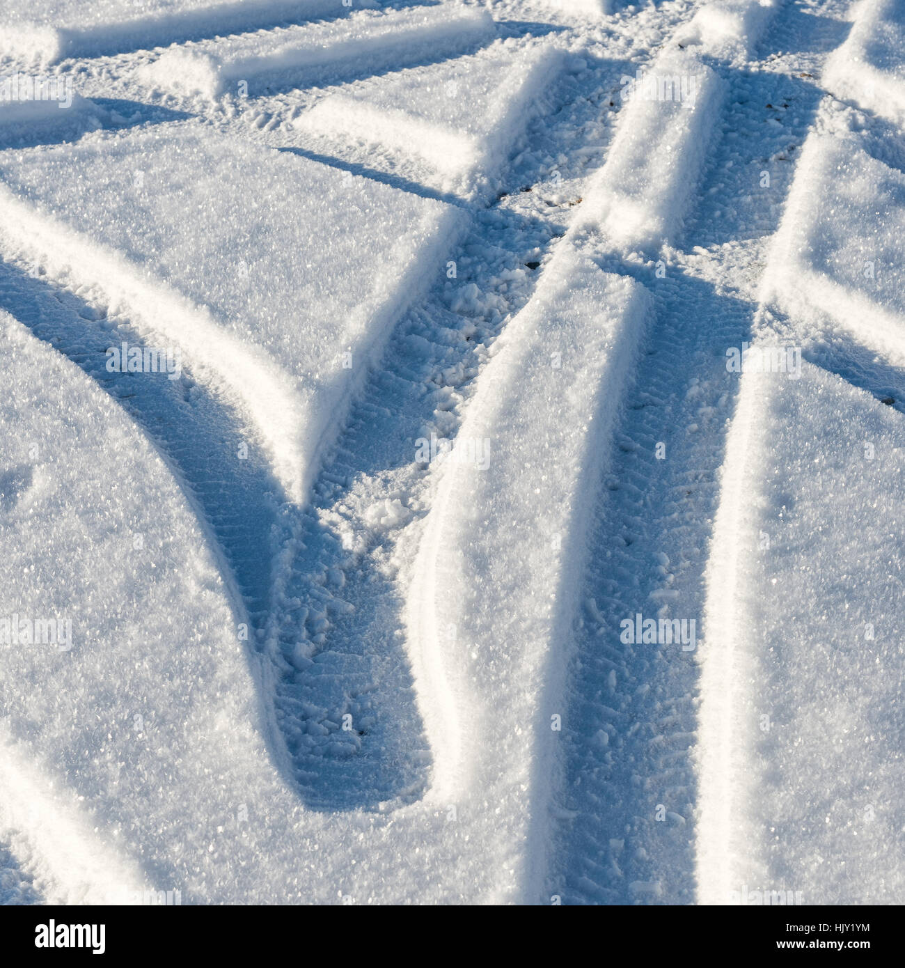 snowy winter road with tire markings and blue sky Stock Photo - Alamy
