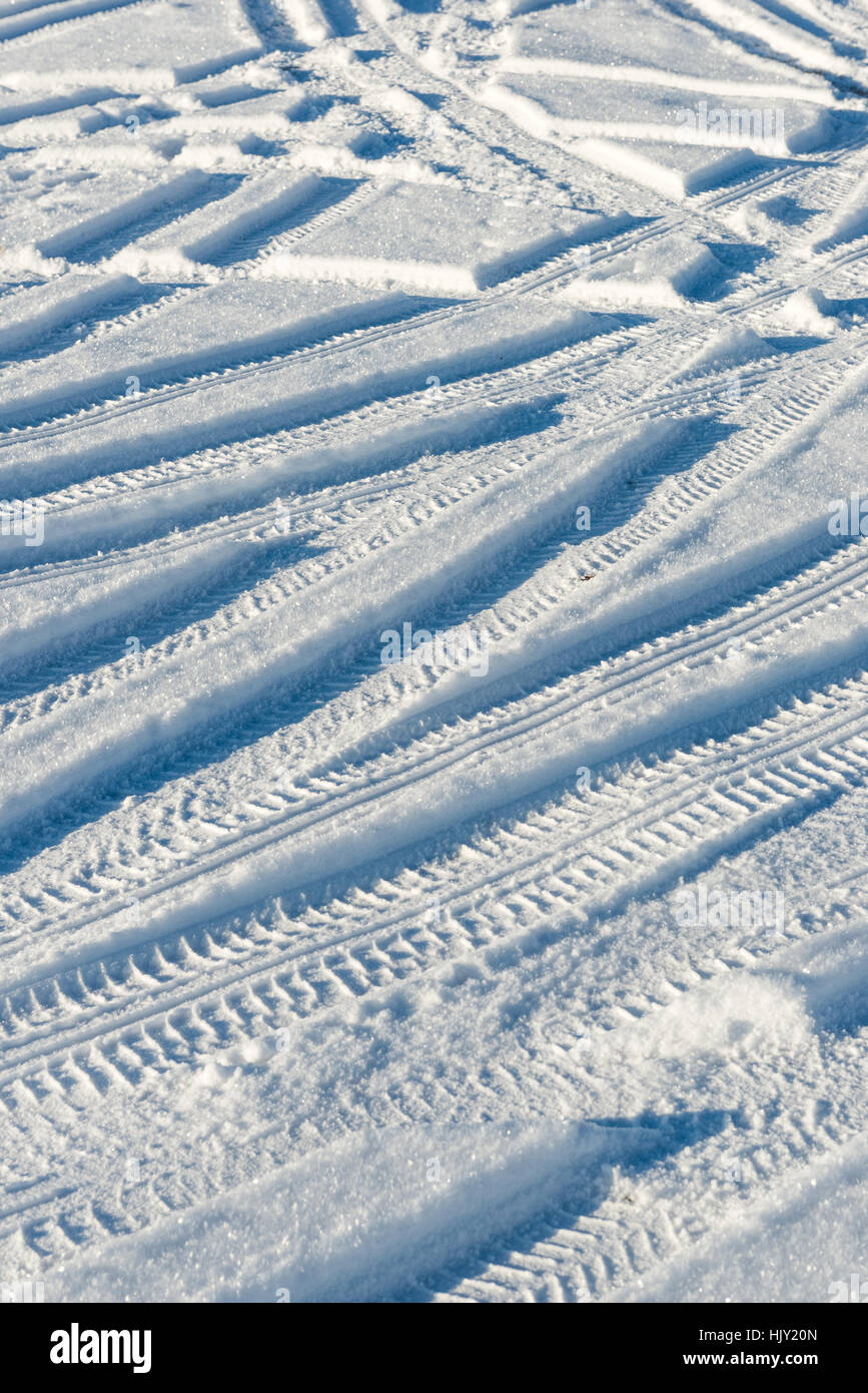 snowy winter road with tire markings and blue sky Stock Photo - Alamy