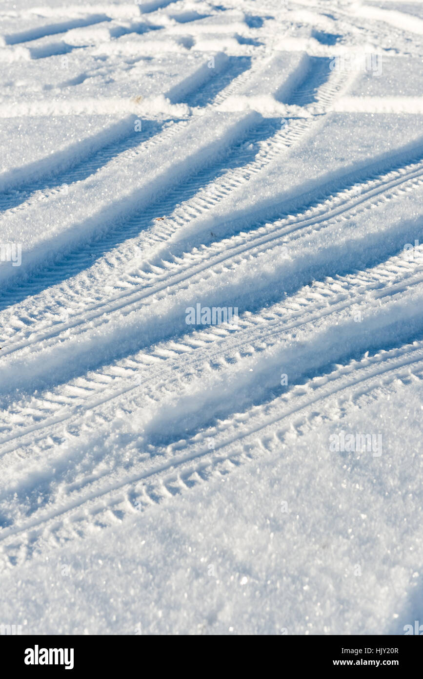 snowy winter road with tire markings and blue sky Stock Photo - Alamy