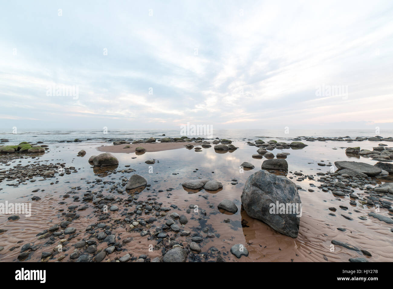 rocky sea beach with wide angle perspective over the sea clouds Stock ...