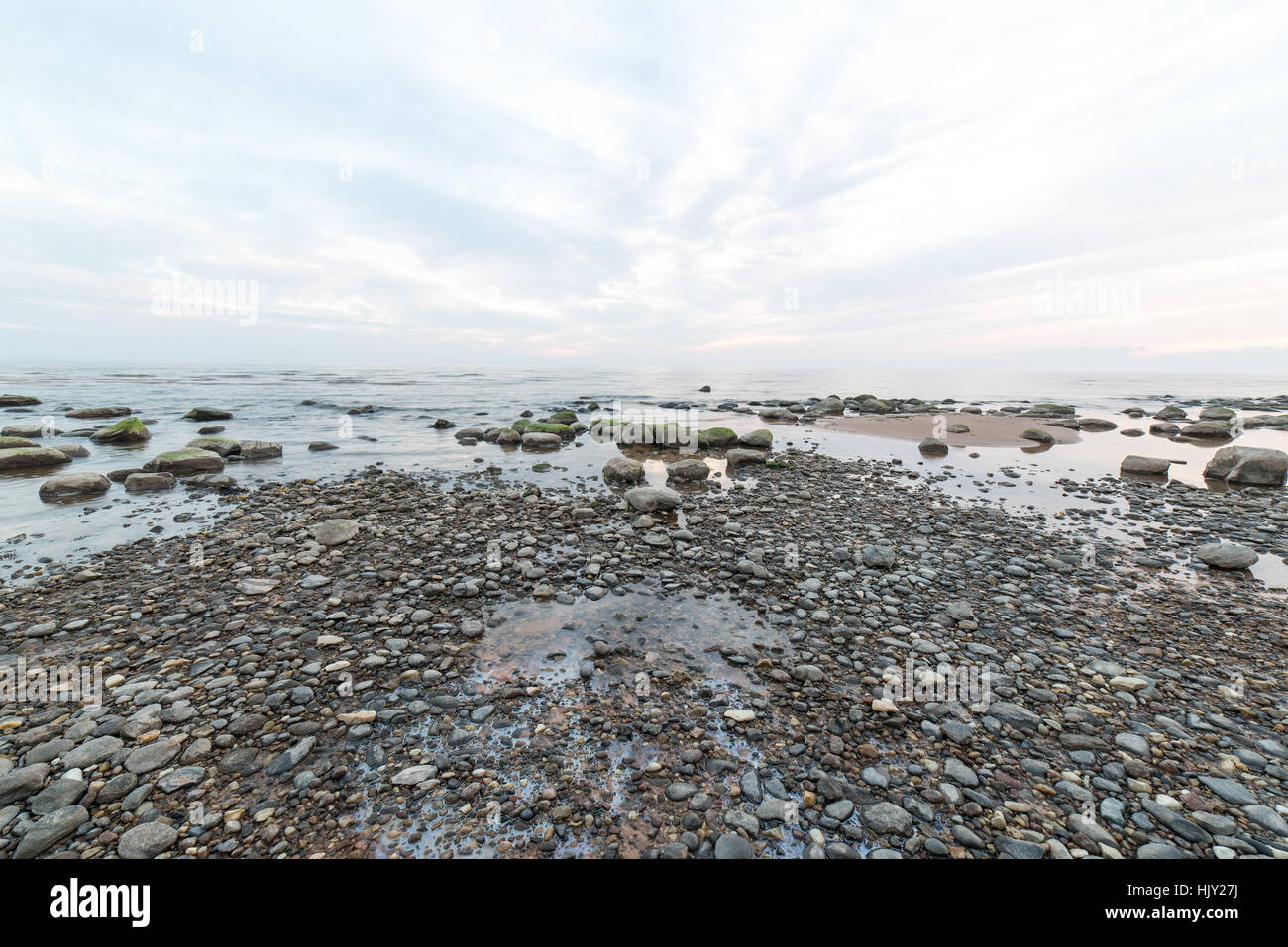 rocky sea beach with wide angle perspective over the sea clouds Stock ...