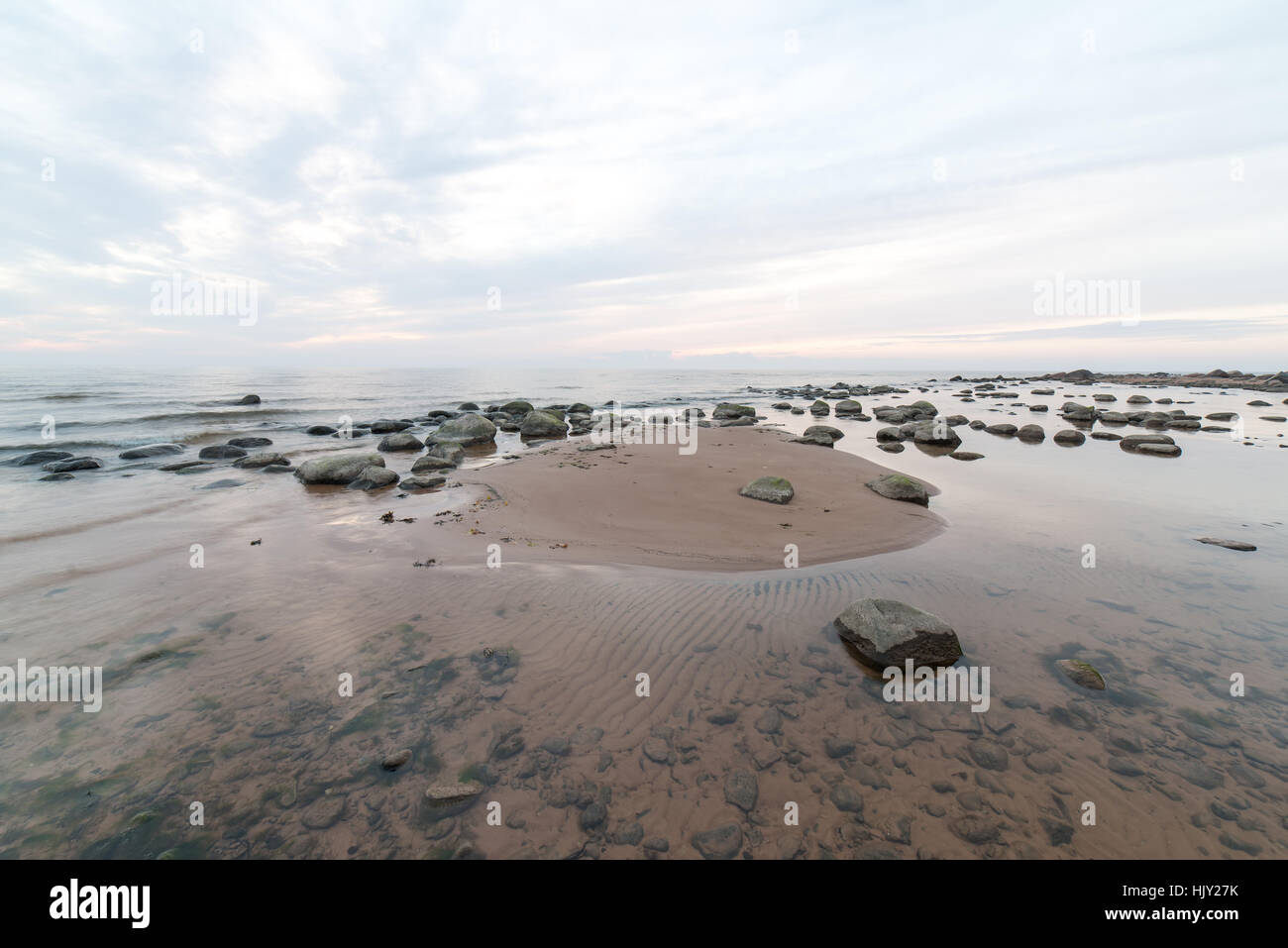 rocky sea beach with wide angle perspective over the sea clouds Stock ...