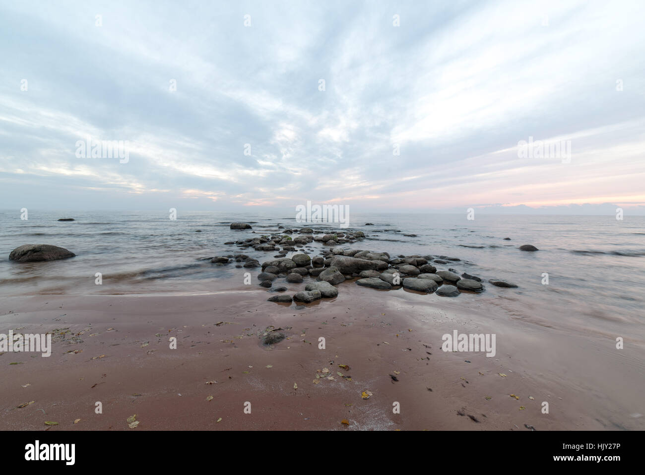 rocky sea beach with wide angle perspective over the sea clouds Stock ...