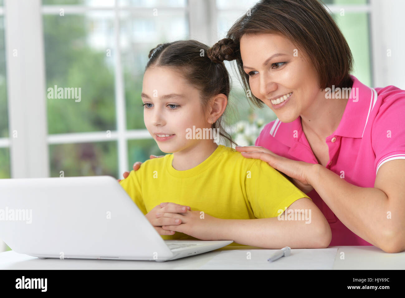 mother and daughter using laptop Stock Photo - Alamy