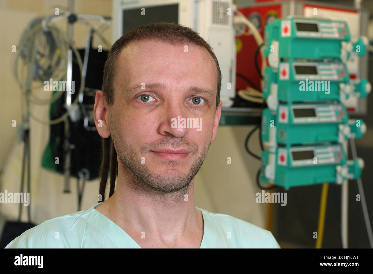 Portrait of male nurse ICU on emergency room.Perfusors and monitor are ...