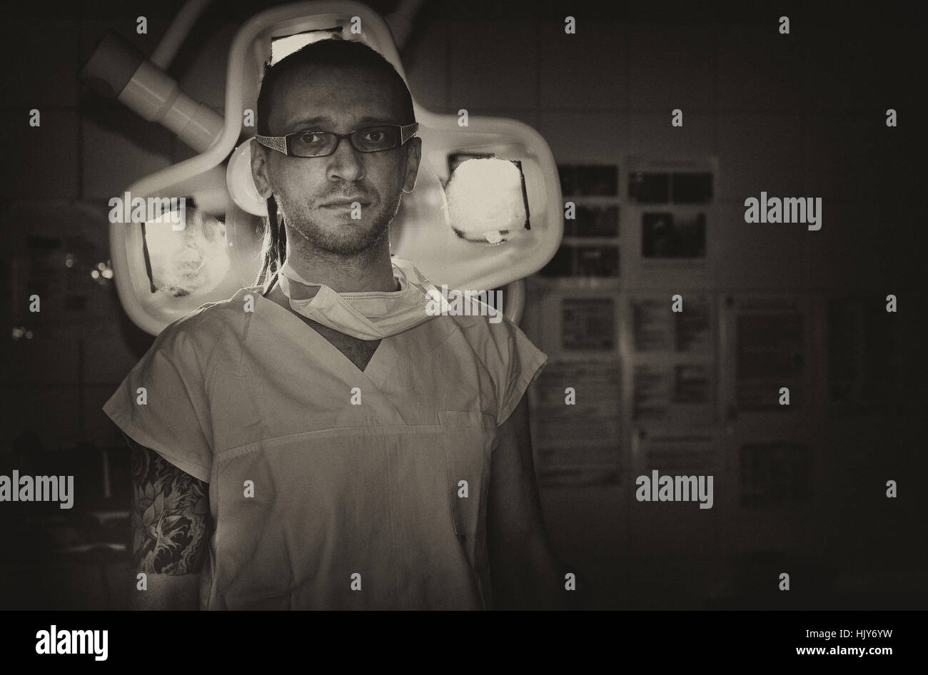 Portrait of male nurse ICU with tattoo and dreadlocks on emergency room ...
