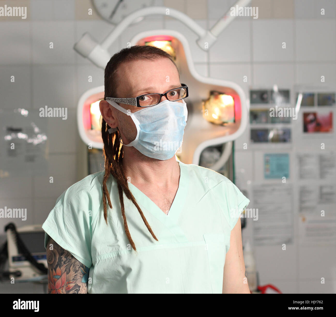 Portrait of male nurse ICU with tattoo and dreadlocks on emergency room ...