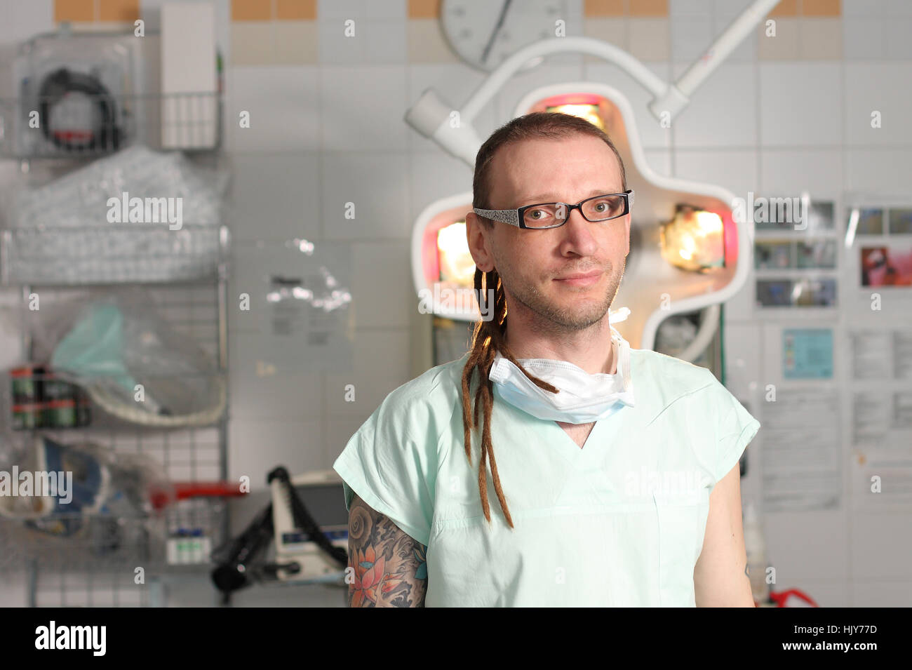 Portrait of male nurse ICU with tattoo and dreadlocks on emergency room ...