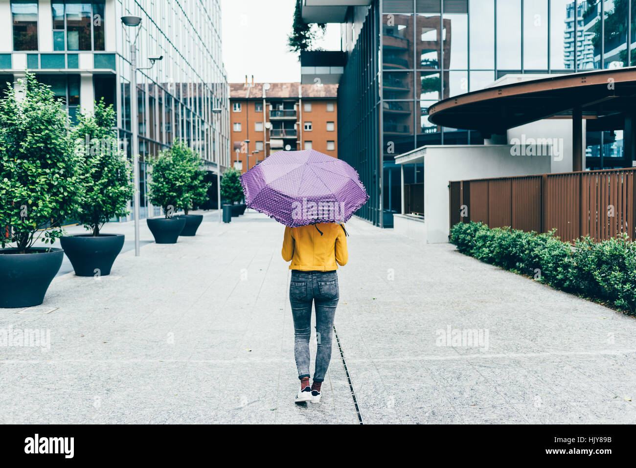 Back view of young woman walking outdoor in rainy day - rainy, weather ...