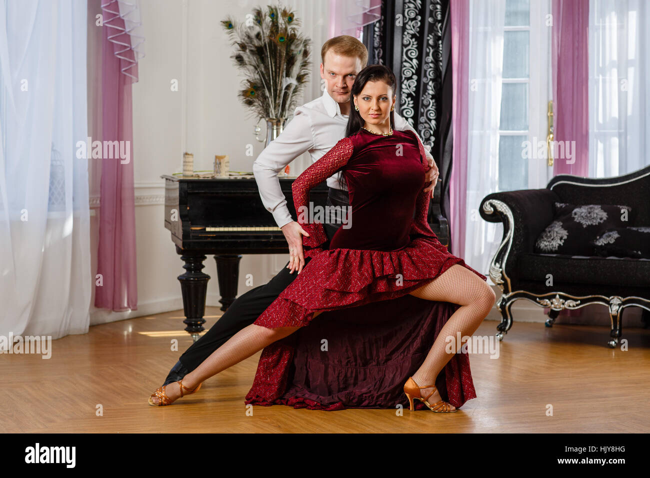 Dancing young couple in the room Stock Photo - Alamy
