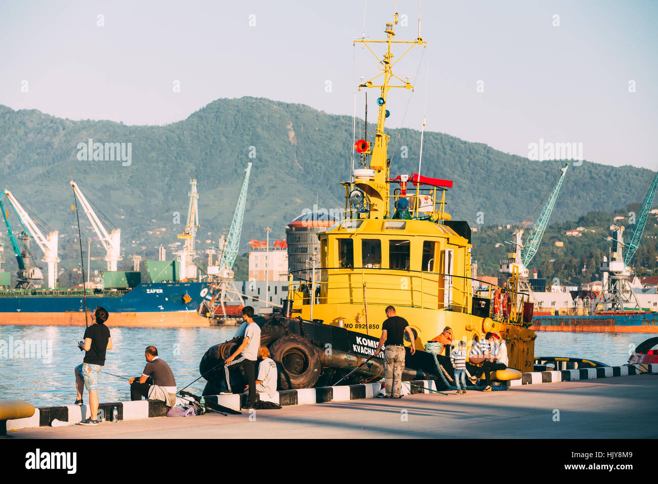 People Fishing Near Old Boat Steamship Ship In Port Dock On Sunny ...