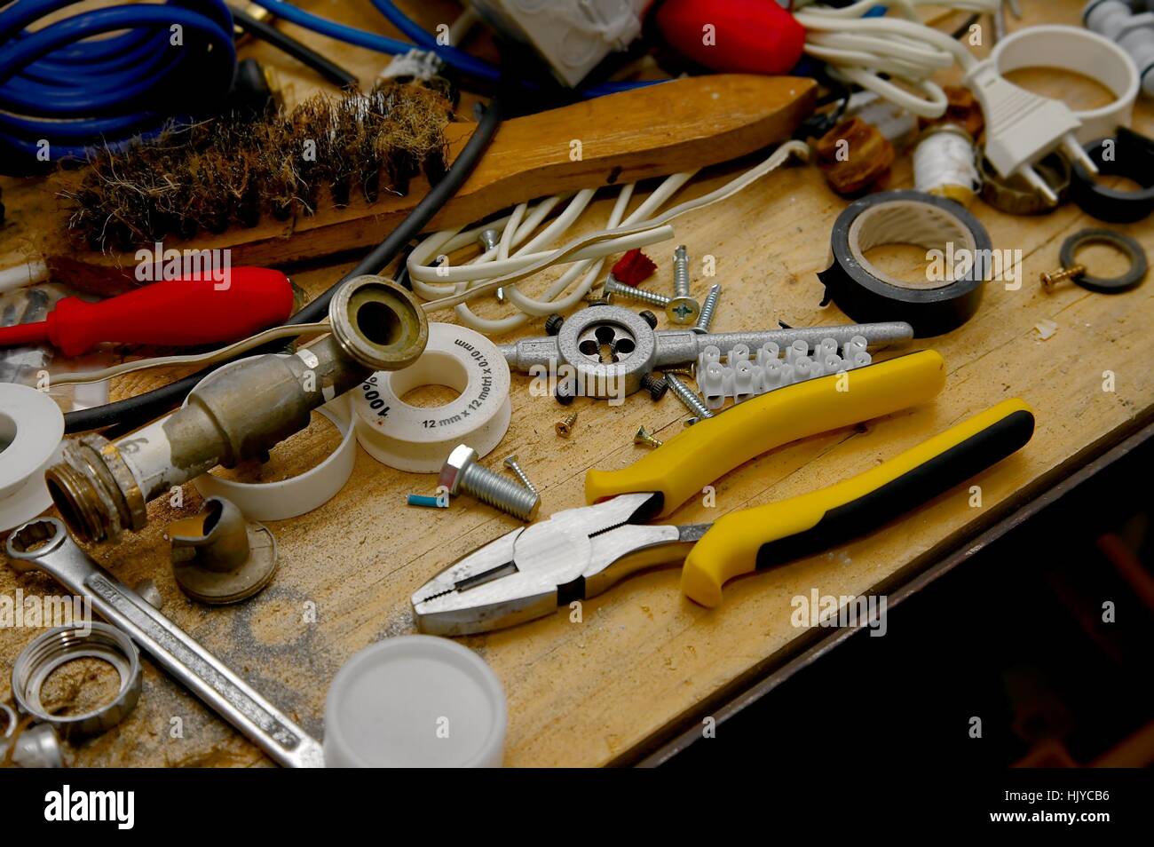 Tools on a messy workshop table Stock Photo - Alamy