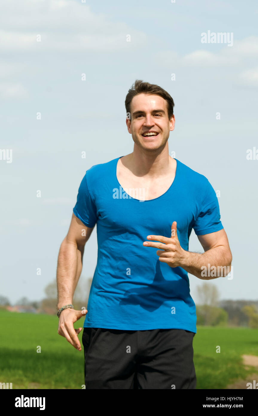man jogging in blue shirt Stock Photo - Alamy