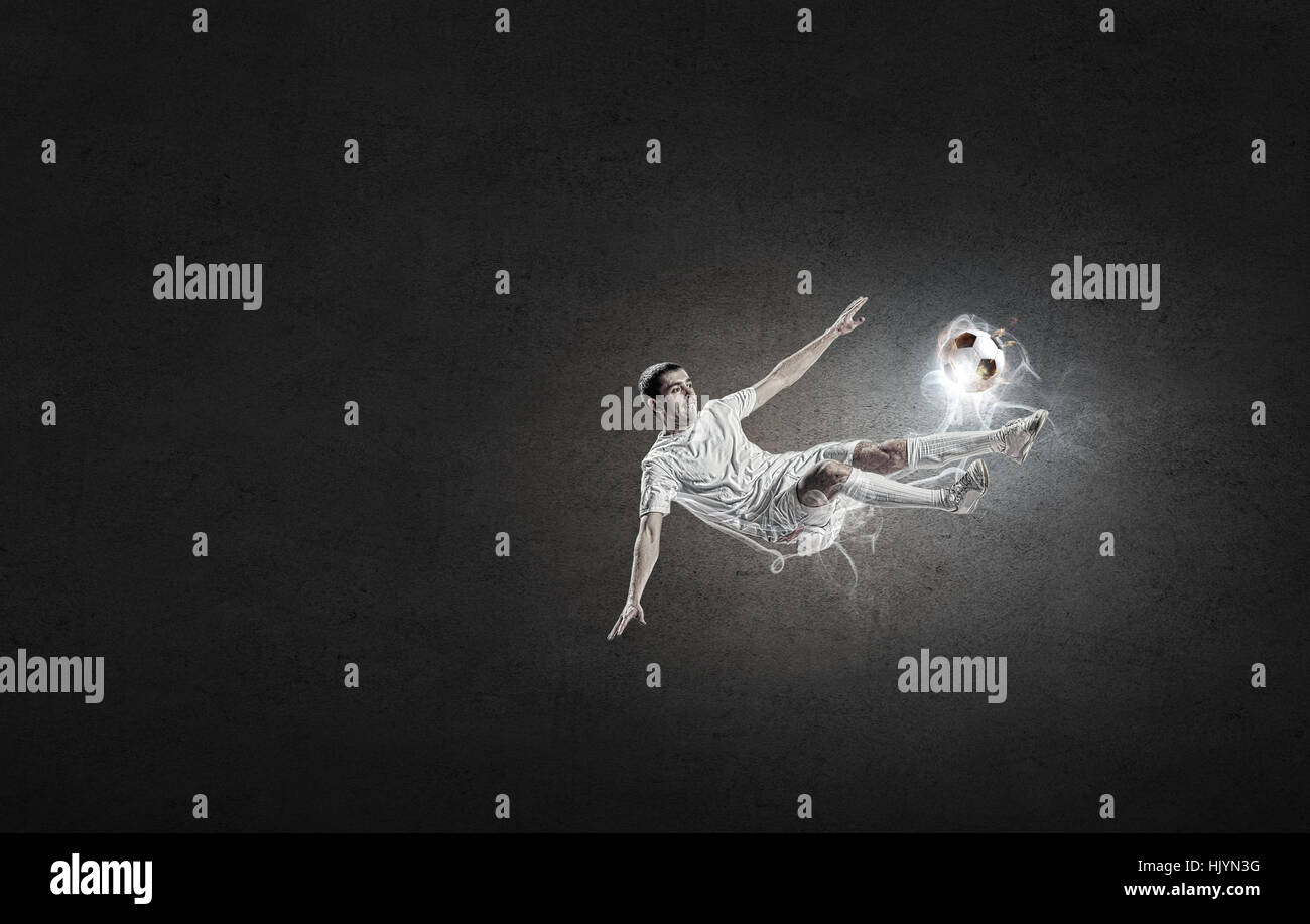 Football player in high jump taking ball Stock Photo - Alamy