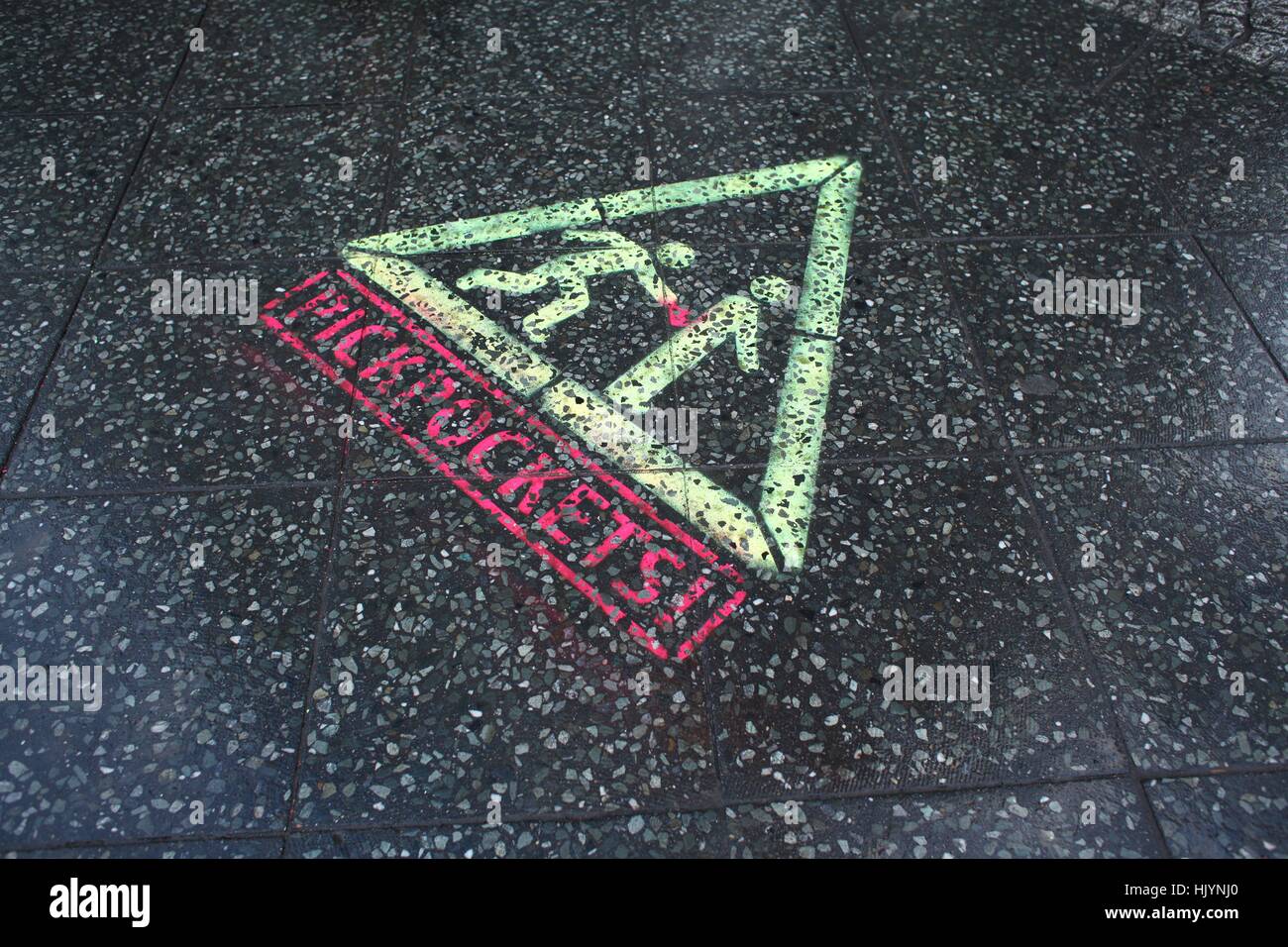 A warning sign in Berlin at Checkpoint Charlie to prevent pickpocketing ...