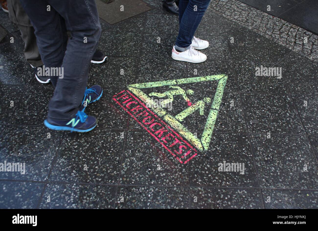 A warning sign in Berlin at Checkpoint Charlie to prevent pickpocketing ...