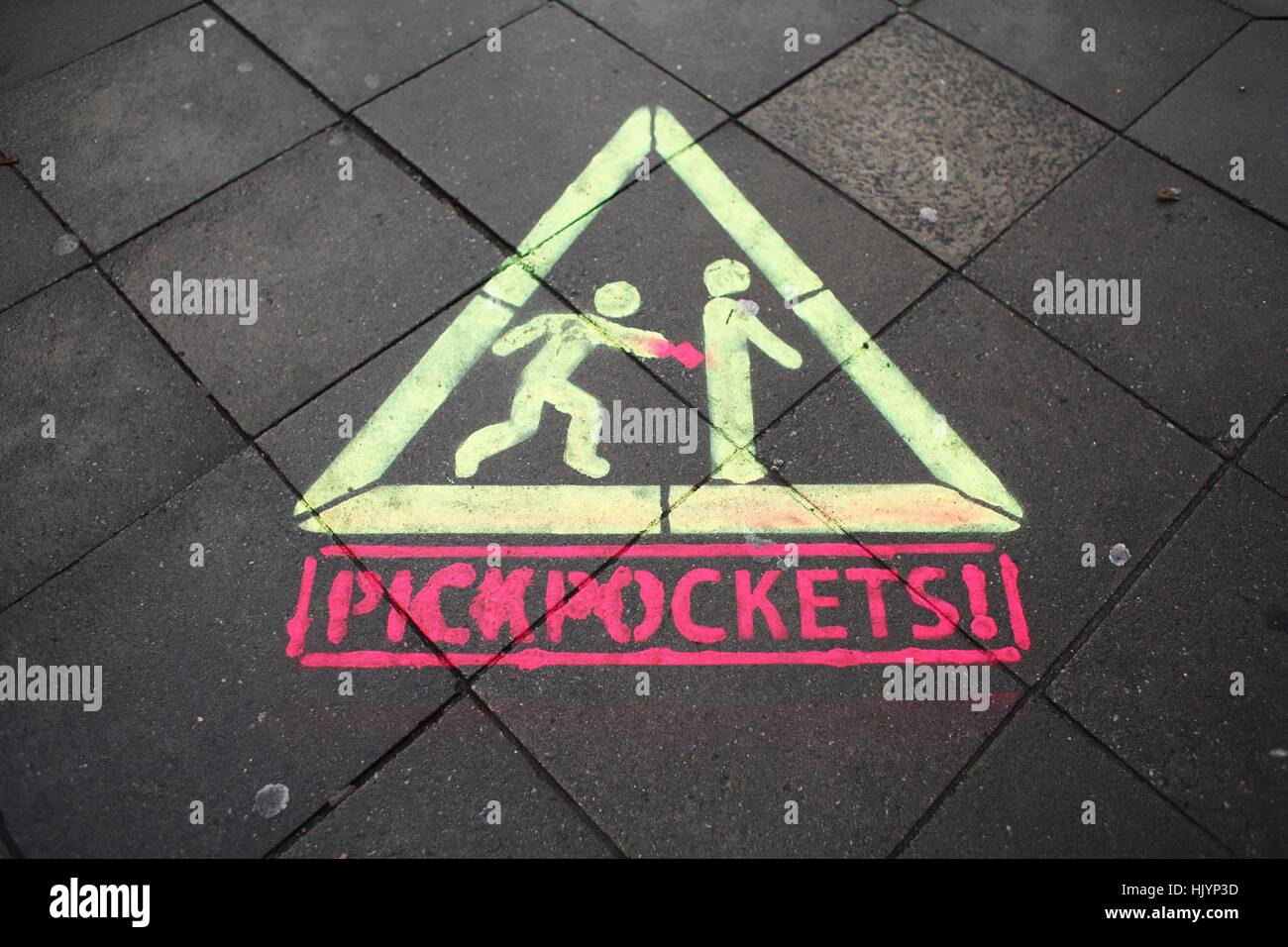 A warning sign in Berlin at Checkpoint Charlie to prevent pickpocketing ...