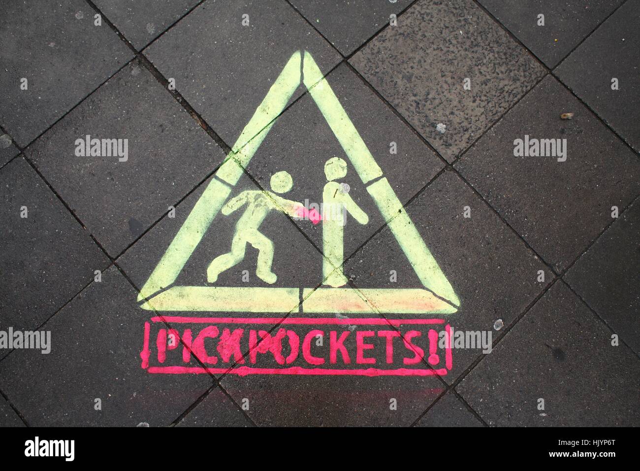 A warning sign in Berlin at Checkpoint Charlie to prevent pickpocketing ...