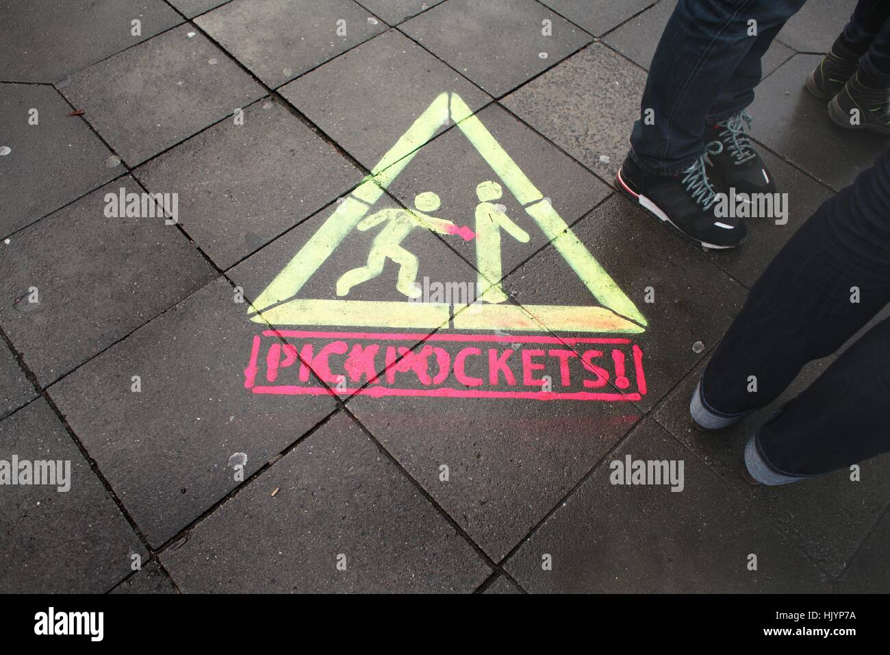 A warning sign in Berlin at Checkpoint Charlie to prevent pickpocketing ...