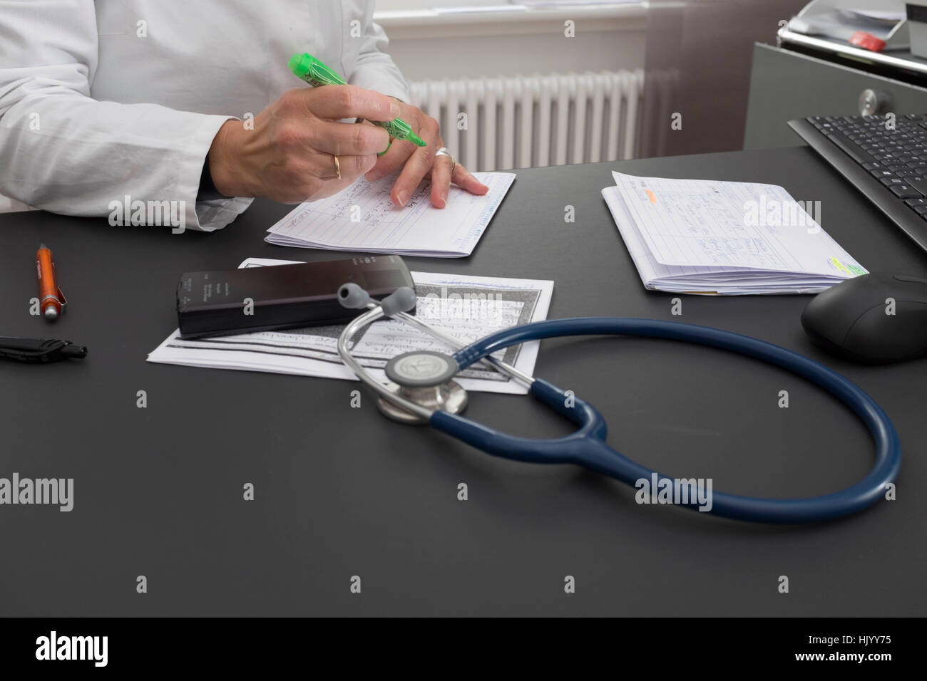 Doctor writes sick note-close-up Stock Photo - Alamy